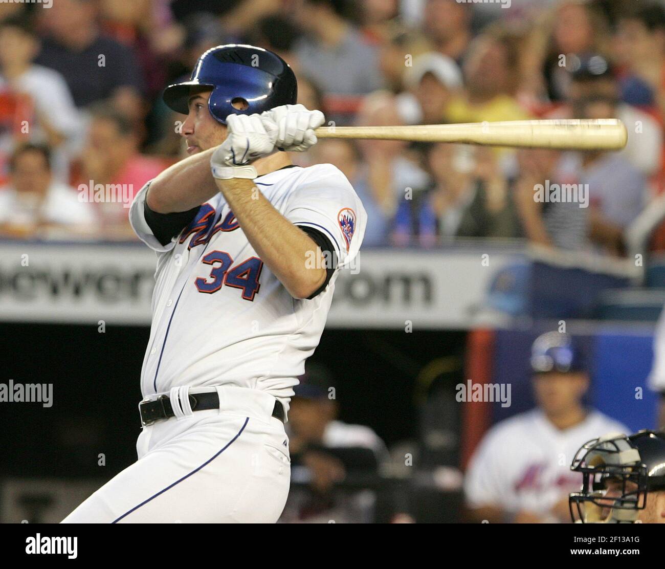 New York Mets Mike Pelfrey hits a RBI single to score Fernando Tatis in ...