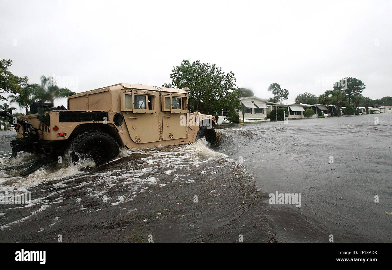 A National Guard Humvee drives through the flooded streets of ...