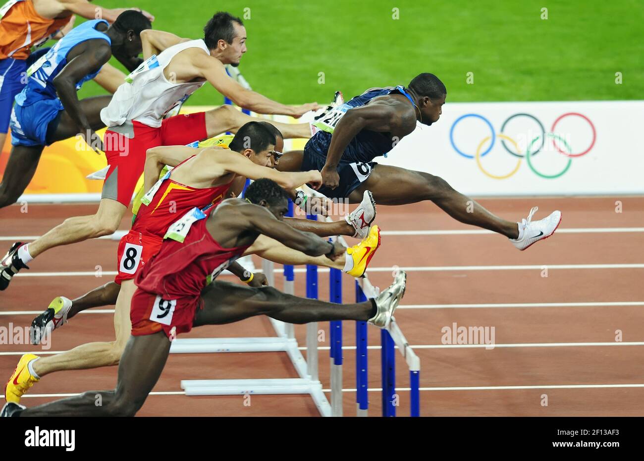 David Oliver of the United States leads the way over a hurdle in the ...