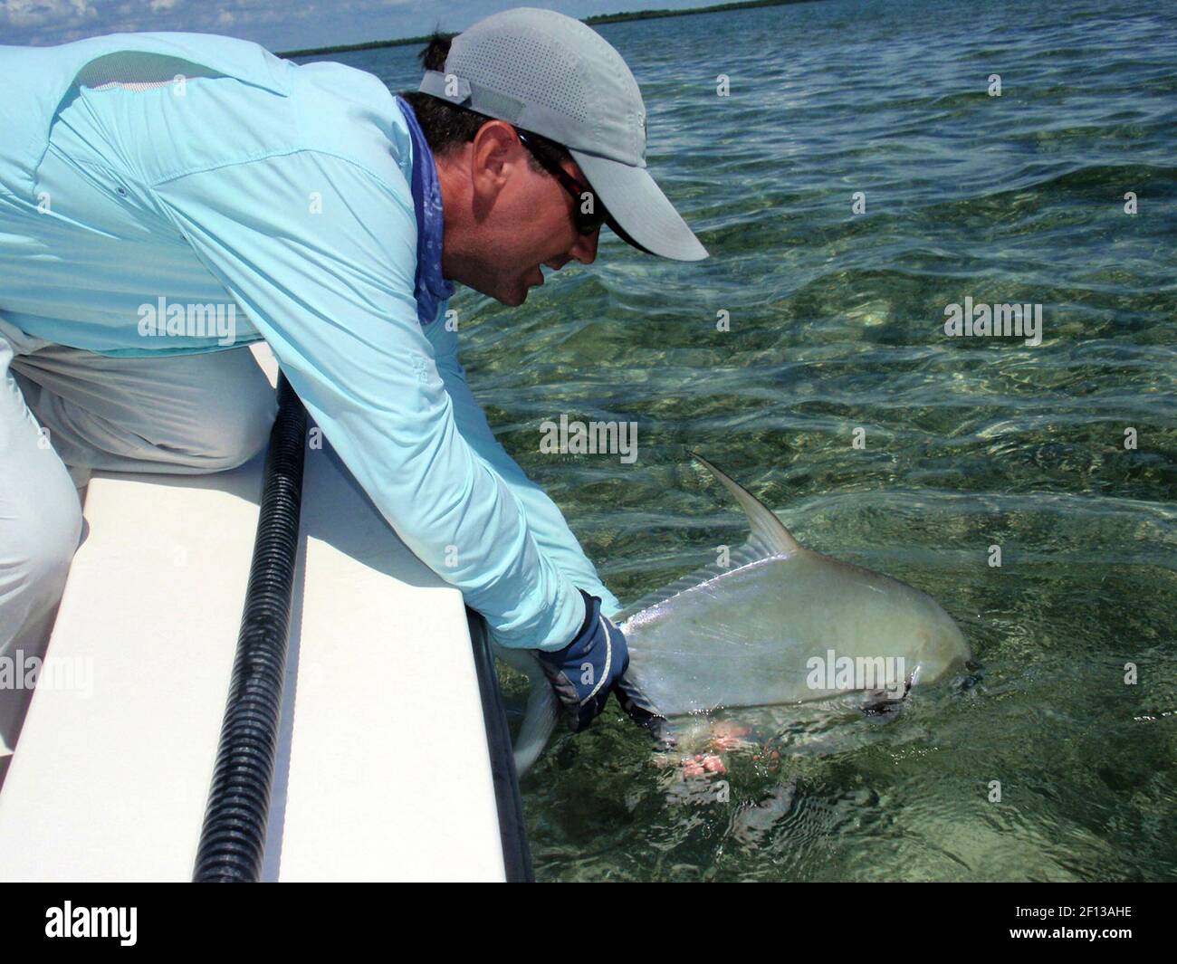 Captain James Koch releasing a 10-pound permit caught by outdoors ...