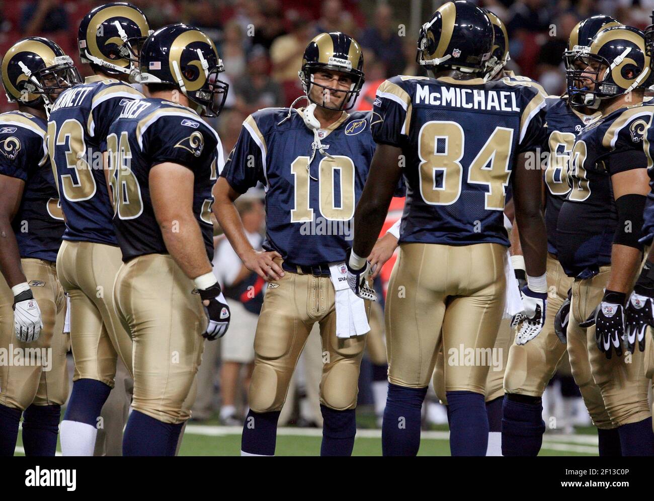 St. Louis Rams quarterback Mark Bulger prepares for a huddle in the ...