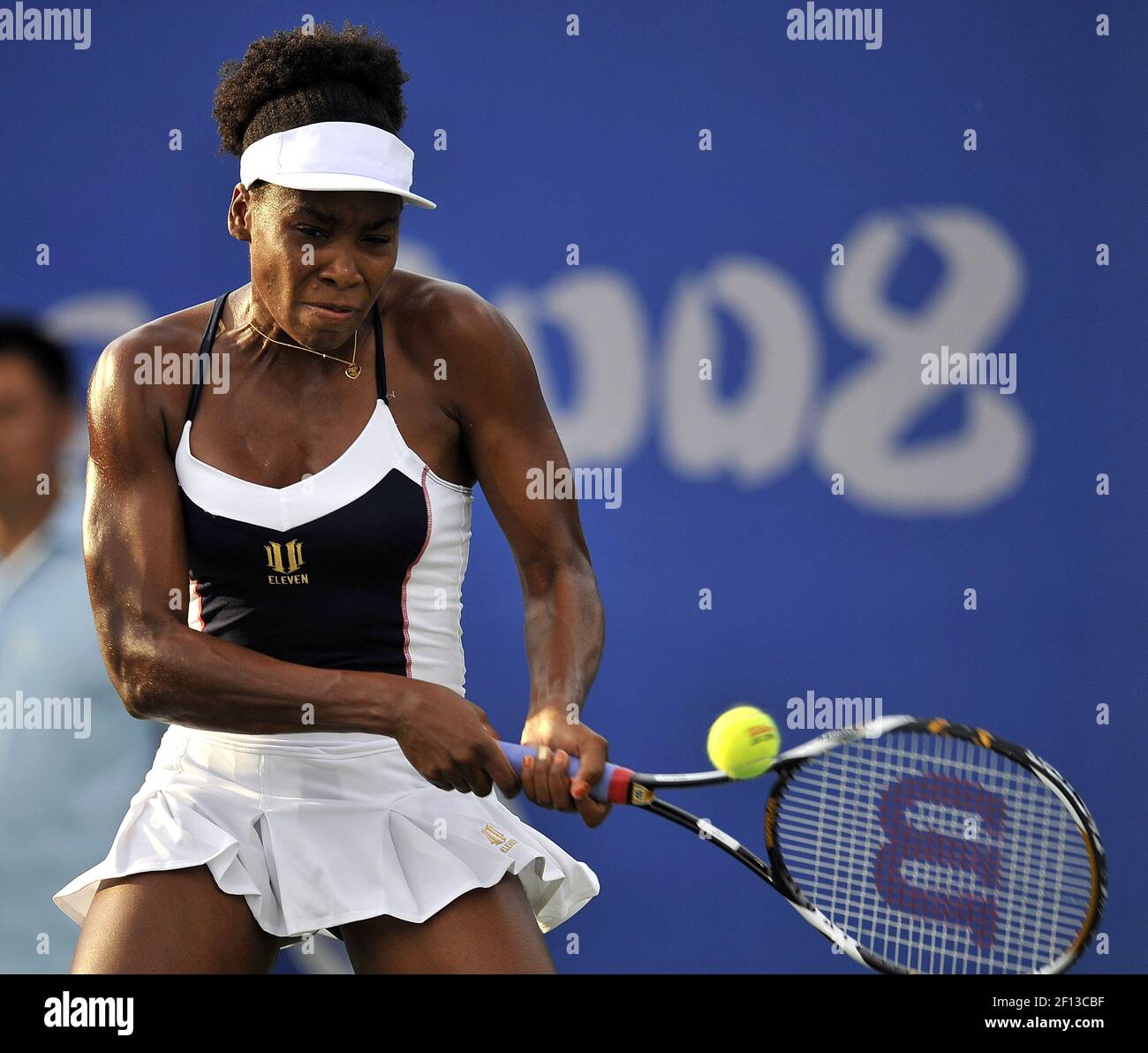 Venus Williams of the United States returns a shot in a doubles match ...
