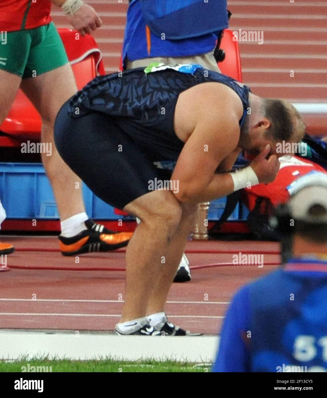 Adam Nelson of the United States hangs his head after faulting on his ...