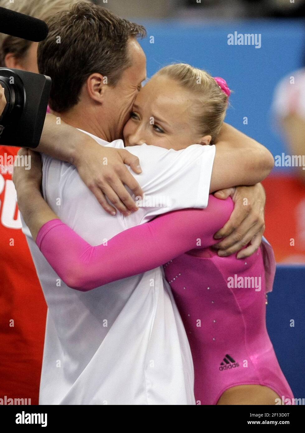 Gold medalilst Nastia Liukin of the United States gets a hug from her ...