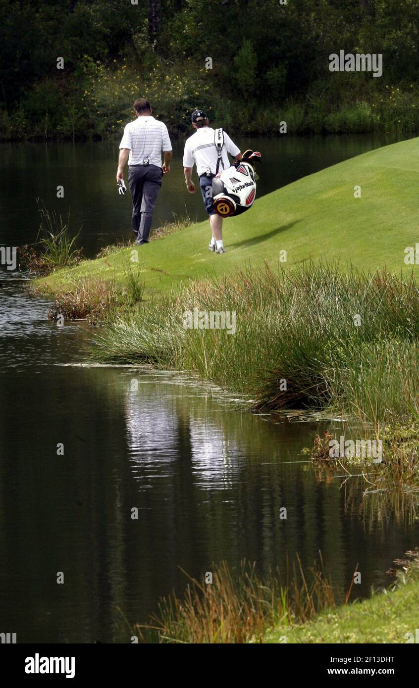 Nick Faldo and his caddie go in seach of Faldo's ball during a ...