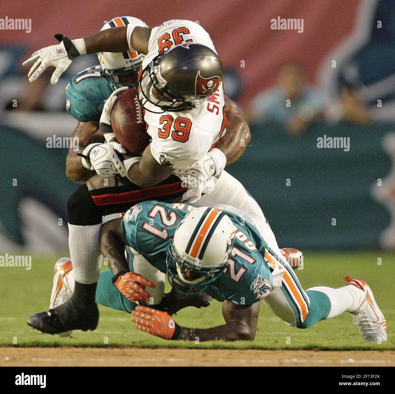 Miami Dolphins Akin Ayodele (back) and Andre Goodman (21) take down Tampa Bay Buccaneers Clifton ...