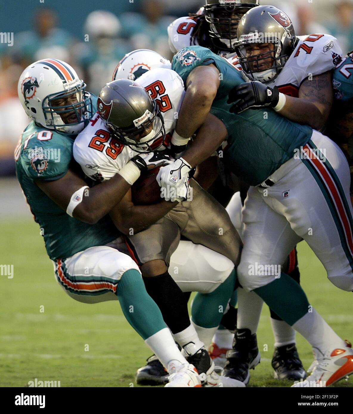 Miami Dolphins Kendall Langford, left, brings down Tampa Bay Buccaneer ...