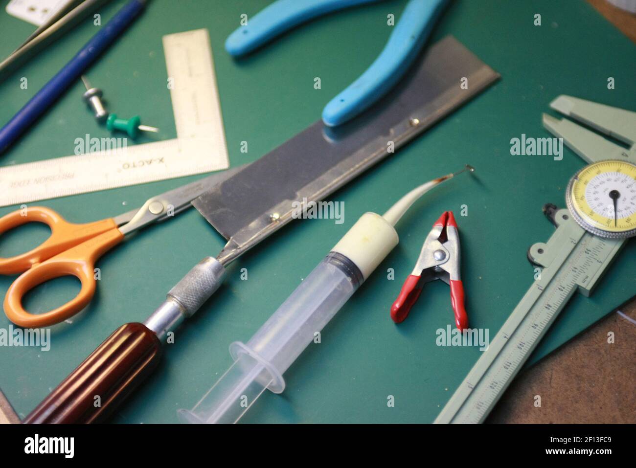 The tools of the model ship-building trade are laid out on a green mat ...