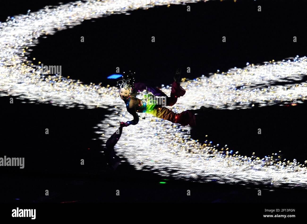 An acrobat flies through the air on wires in the National Stadium ...