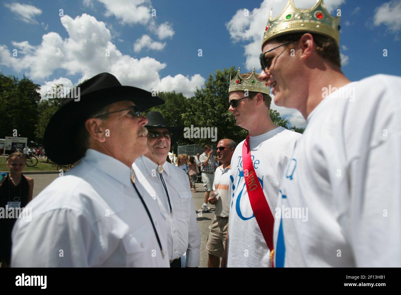 Gary (left) and Larry Grim, from Michigan, chat with their friends ...