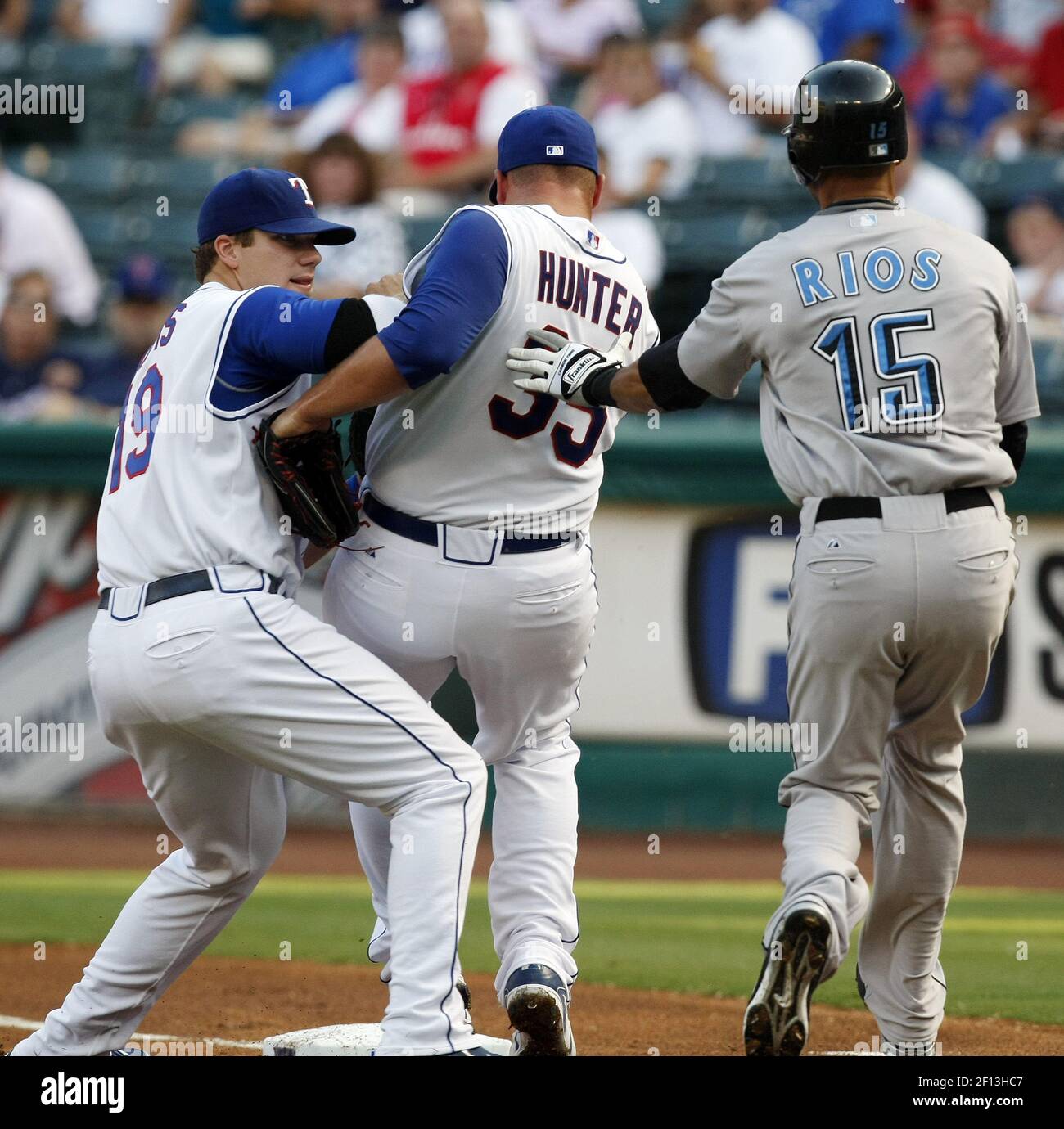 Texas Rangers rookie starting pitcher Tommy Hunter, center, is charged ...