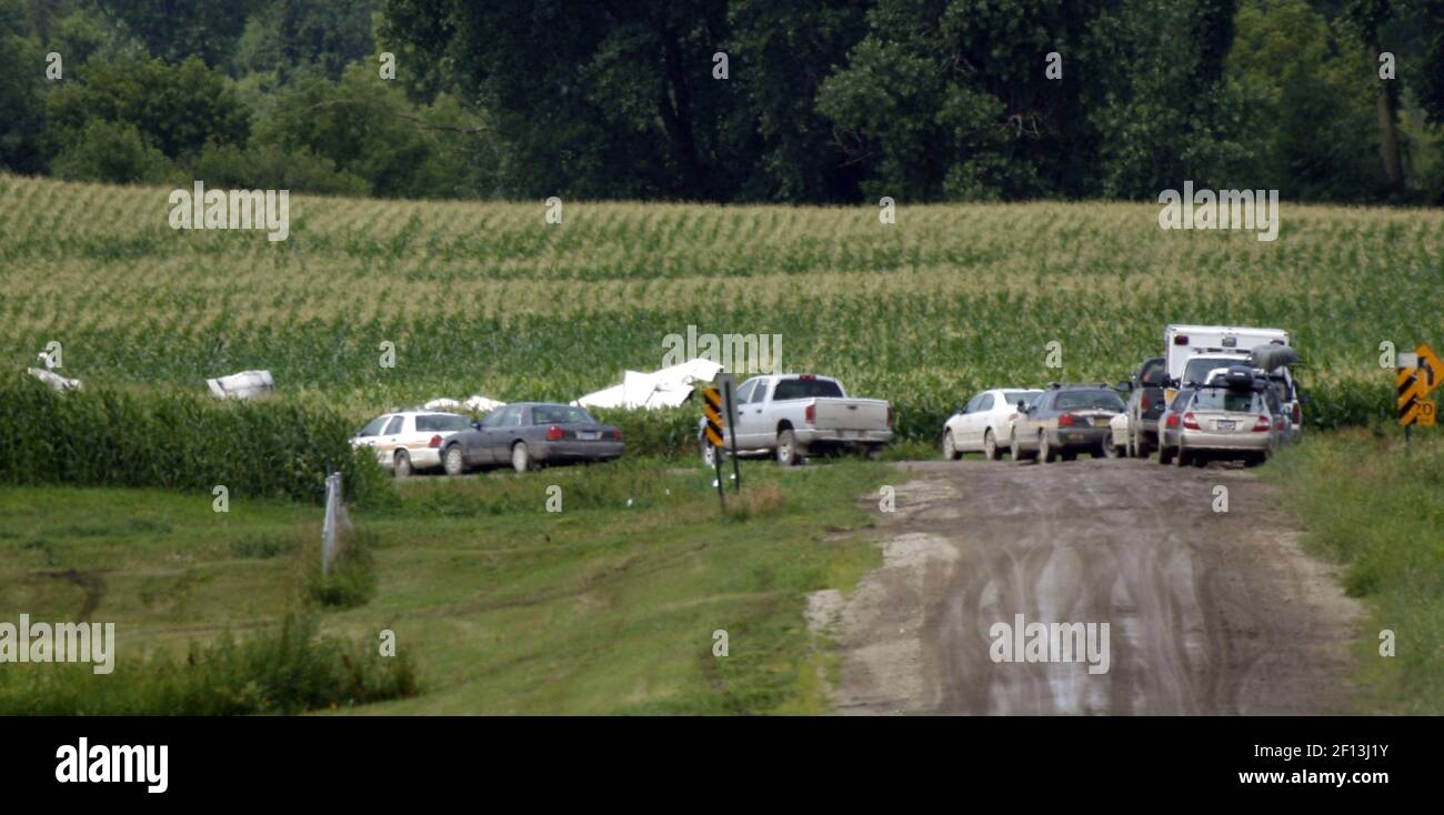 Emergency personnel investigate the scene of a fatal airplane crash ...