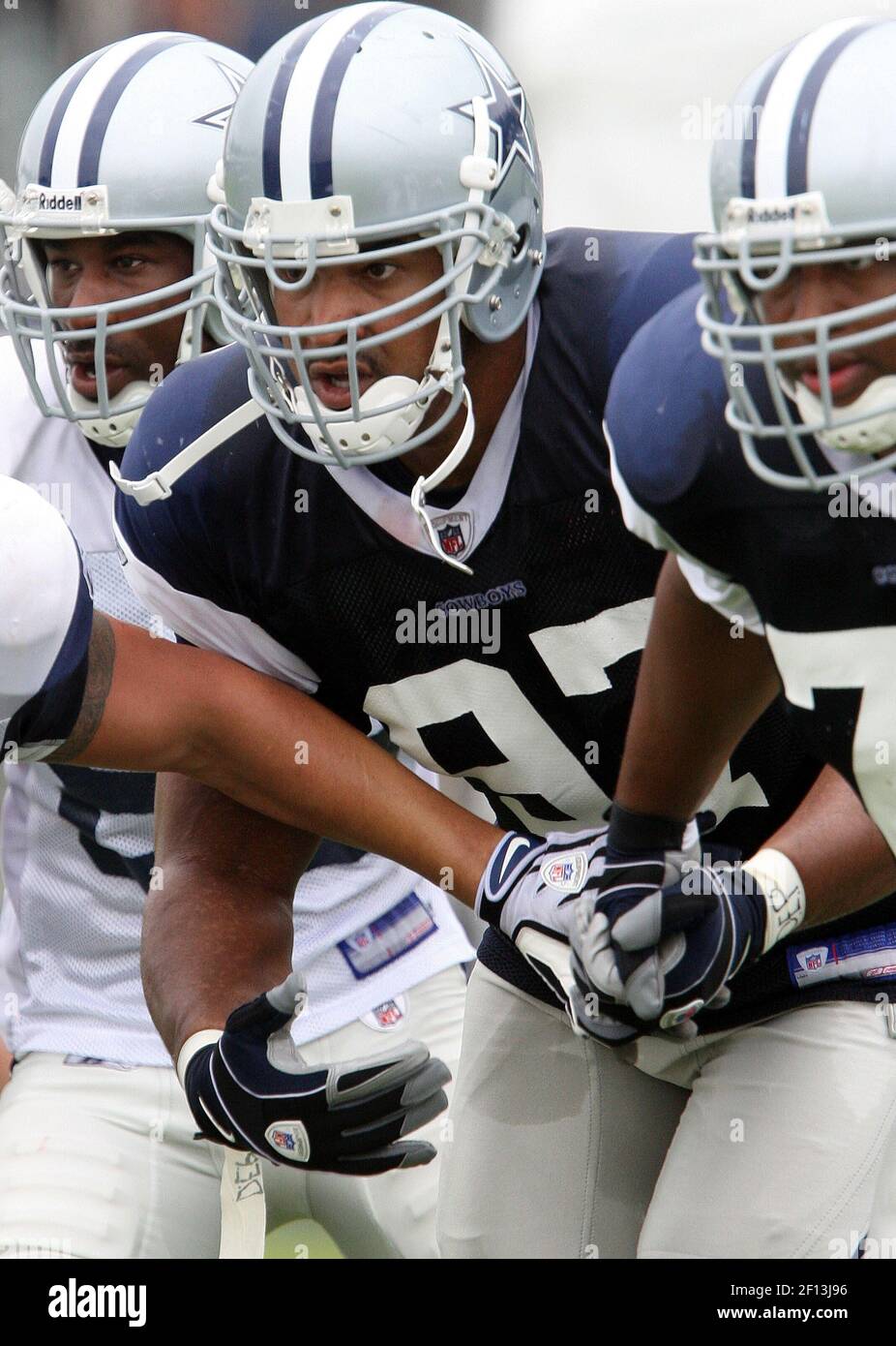 Dallas Cowboys defensive end Jason Hatcher (middle) runs through drills ...