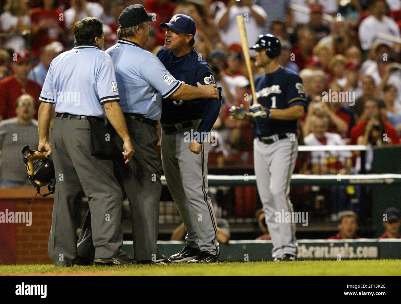 Umpire Joe West gets between home plate umpire Ed Rapuano and Milwaukee ...
