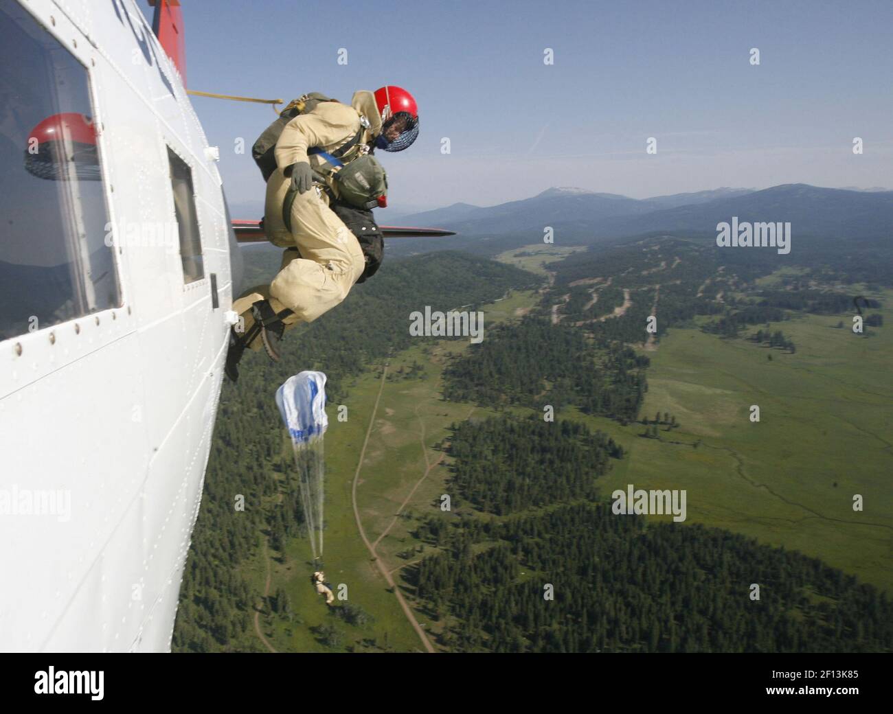 Smokejumper Larry Wilson exits a DC-3TP airplane during training jumps ...
