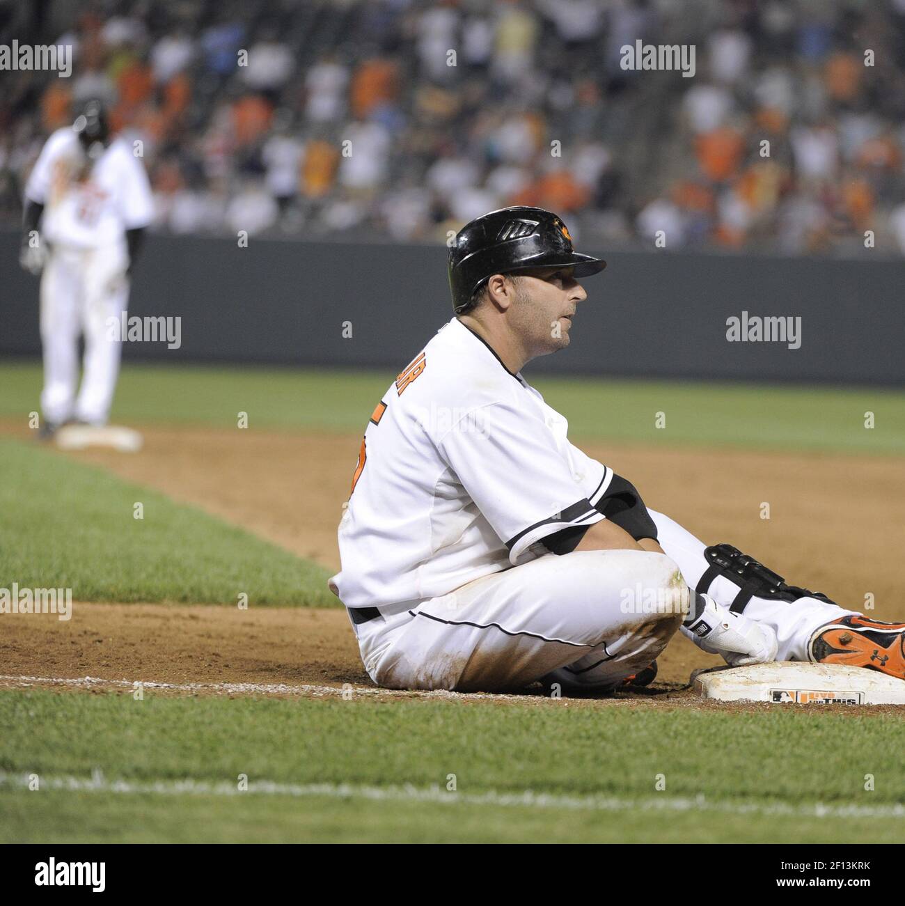 Baltimore Orioles Kevin Millar sits dejectedly on first after he made ...