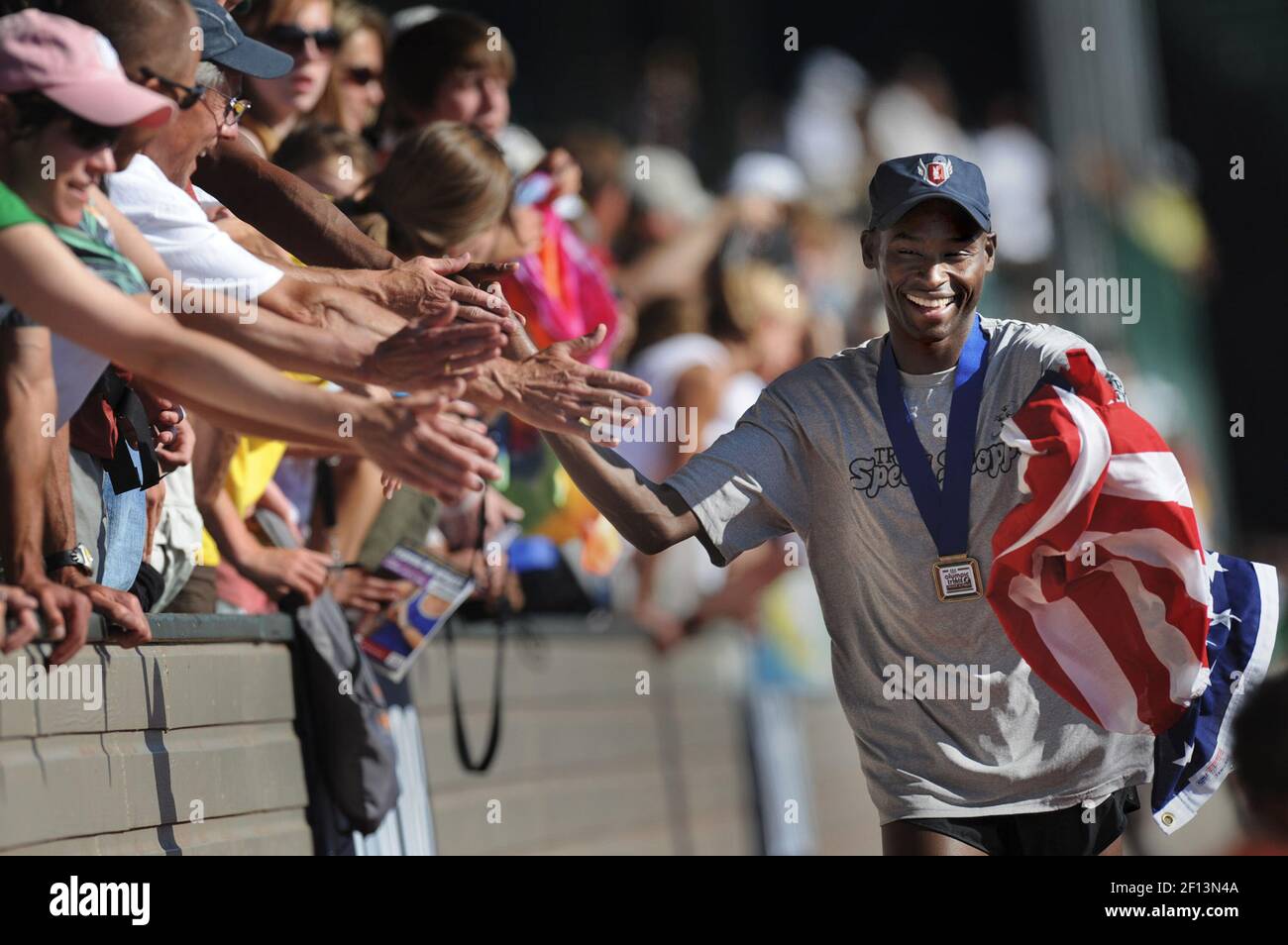 Bernard Lagat greets the fans at Hayward Field after he won the men's ...