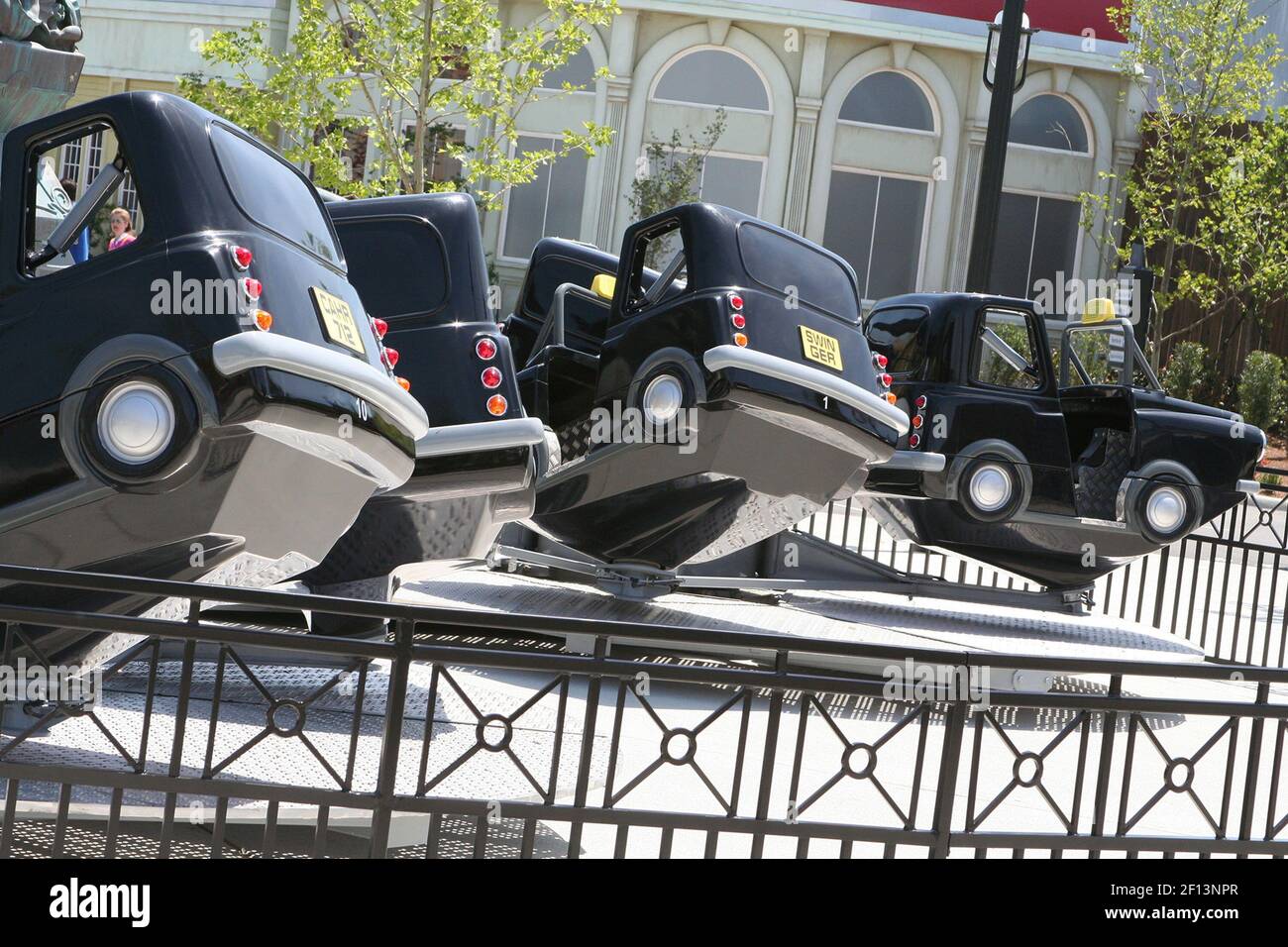 The cars of an octopus-like ride are disguised as London taxicabs at ...