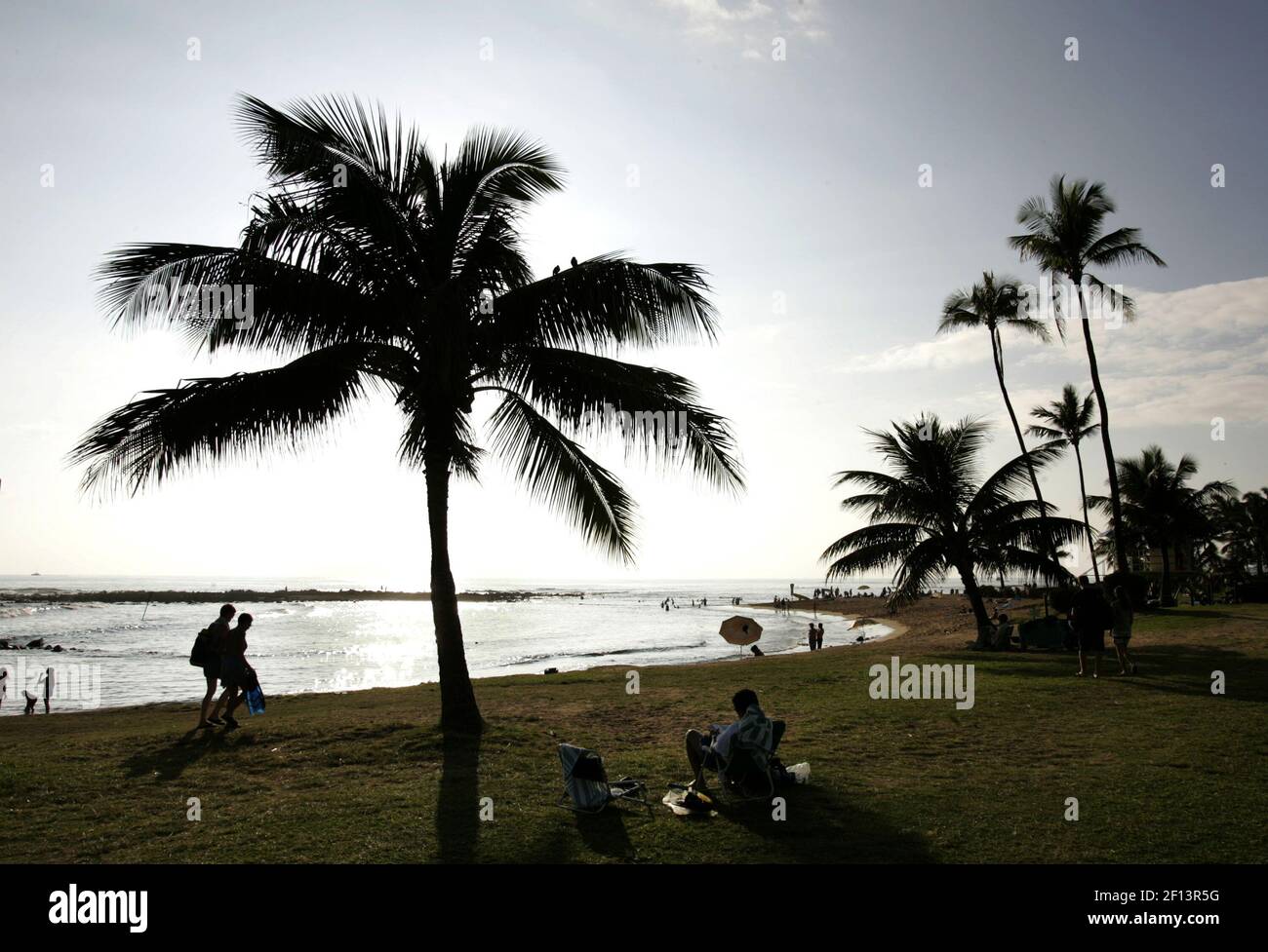 Poipu Beach, with its rocky shoal, creates a placid lagoon and gently ...