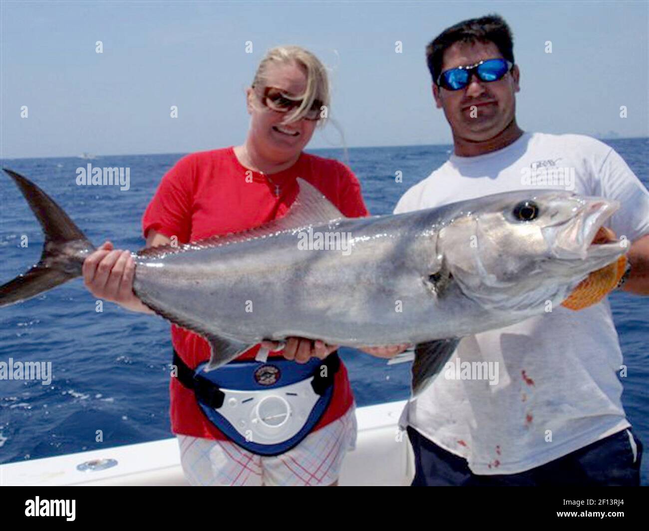 DeeDee Pegg and captain Ralph Hawkins hold an amberjack that Pegg ...