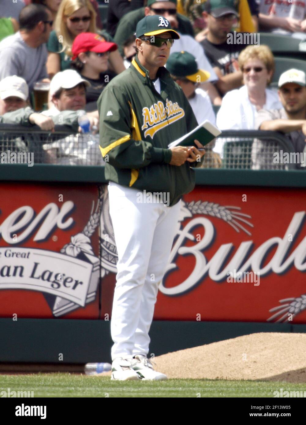 Oakland Athletics bullpen coach Ron Romanick watches his pitchers warm ...