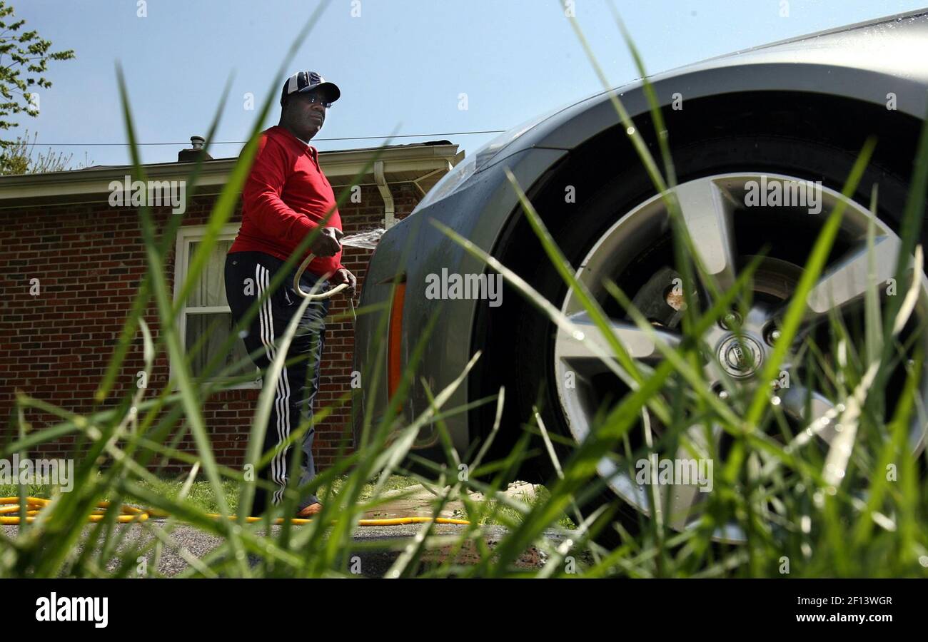 Chuck Runnels washes his car at his family's home in Meacham Park in ...