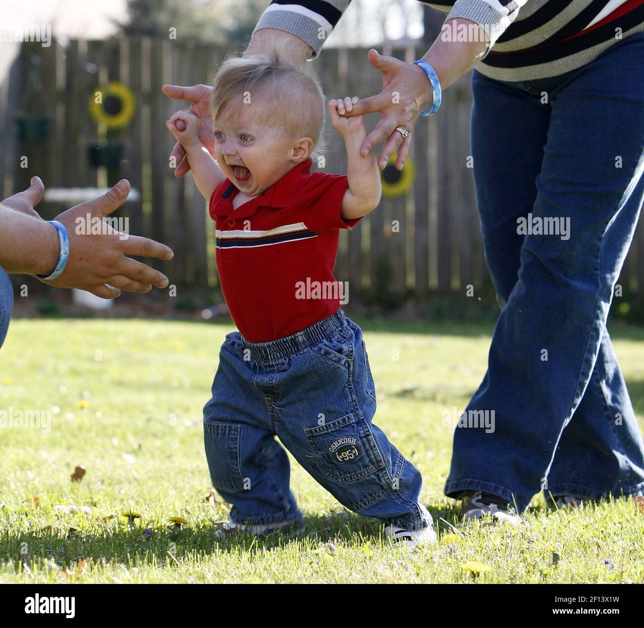 Zach Pickard, 14 months old, walks with the help of his mom, Tina ...