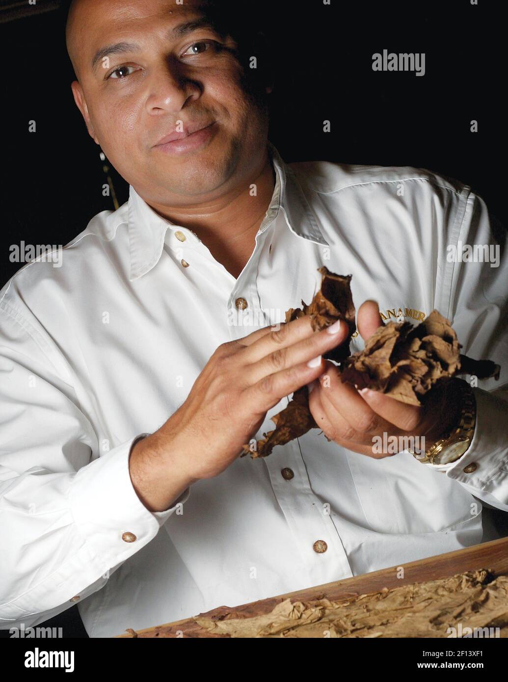Master cigar roller Adonis Arteaga with the essential elements of a ...