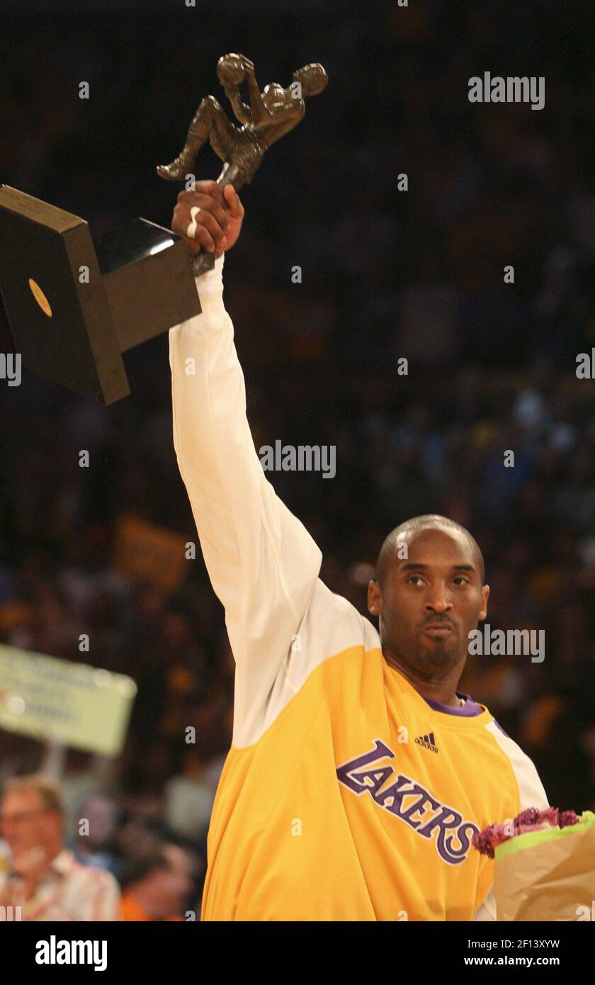 Los Angeles Lakers guard Kobe Bryant hoists the MVP trophy prior to the ...