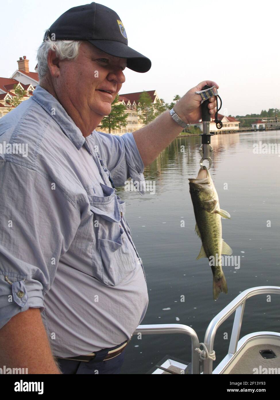 Fishing guide Charlie Brown weighs a bass during an excursion at Walt ...