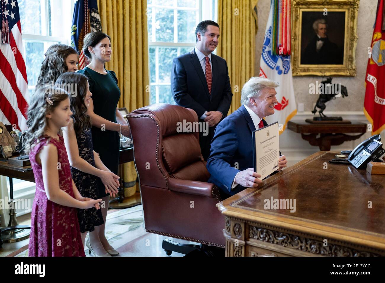 President Donald Trump displays his signature on the citation honoring ...