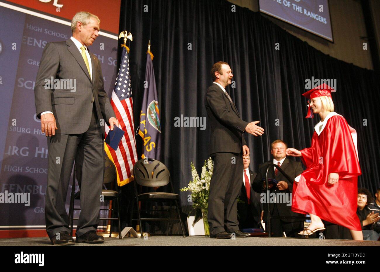 President George W. Bush (left) helps hand out diplomas during the ...