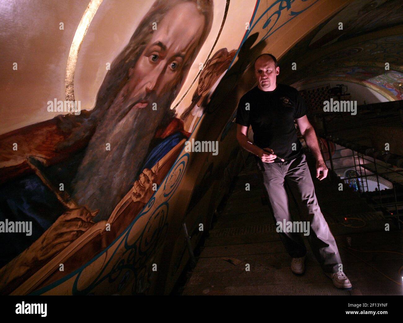 Russian iconographer Valery Butyrsky, shows the oil painting he is ...