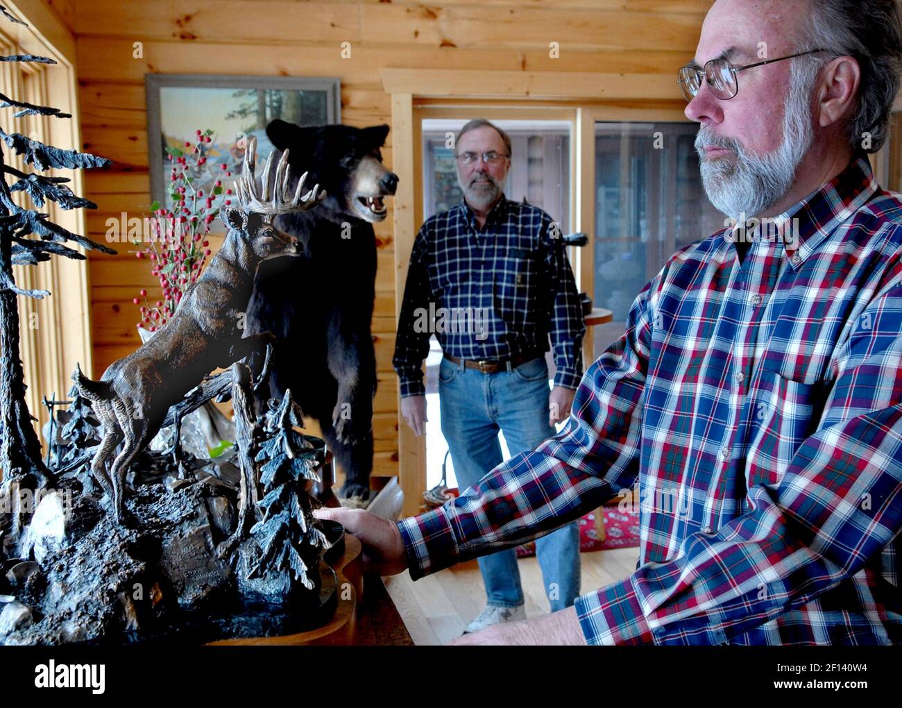 Bud Burger, of Burger Brothers Sporting Goods, (foreground) spends his ...