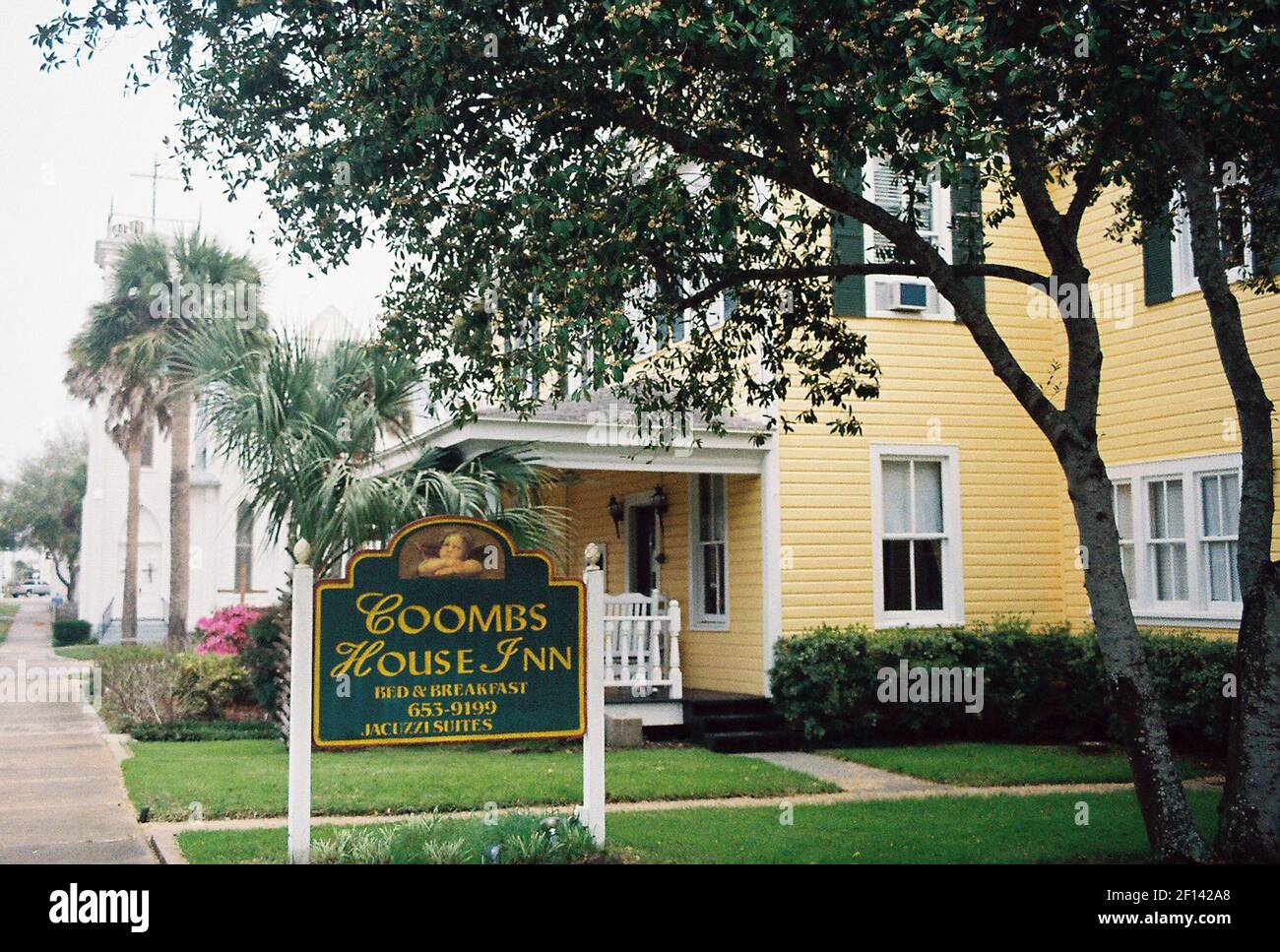 The elegant Coombs House Inn is the three-story bright yellow mansion ...