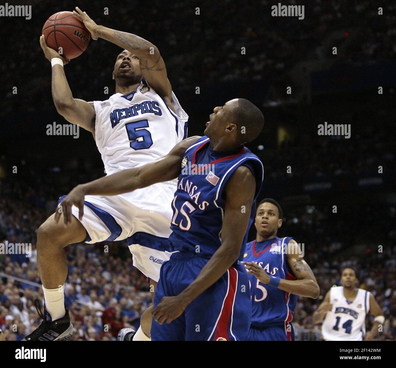 Memphis guard Antonio Anderson heads for the basket past Kansas guard ...