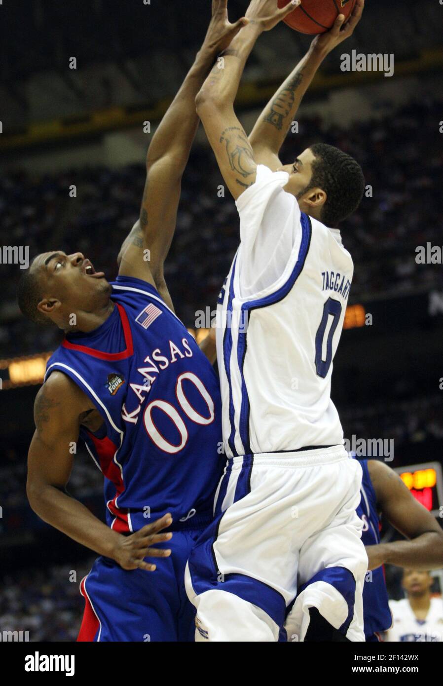 Memphis' Shawn Taggart puts up a shot against Kansas defender Darrell ...