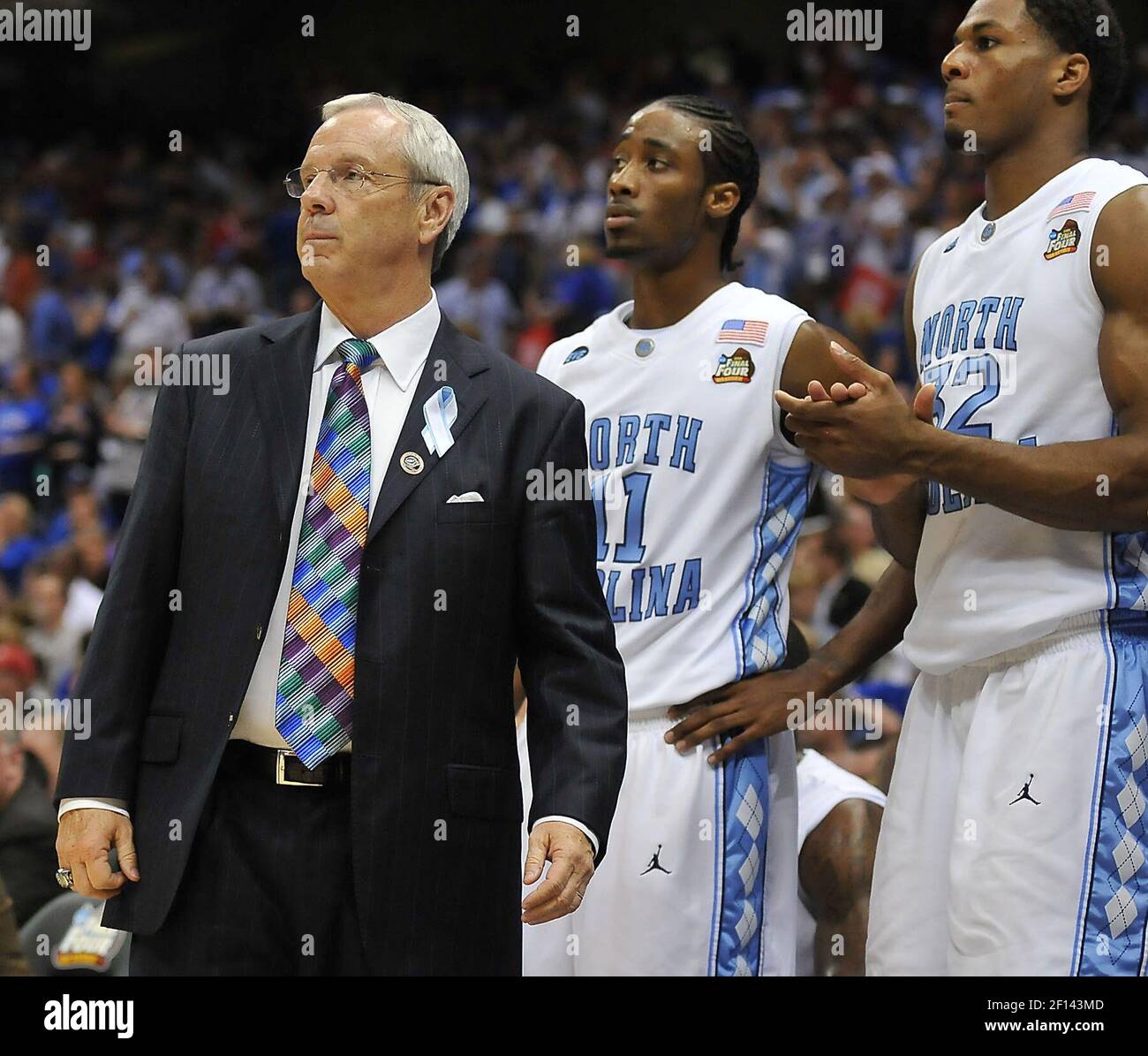 North Carolina head coach Roy Williams stands in front of players ...