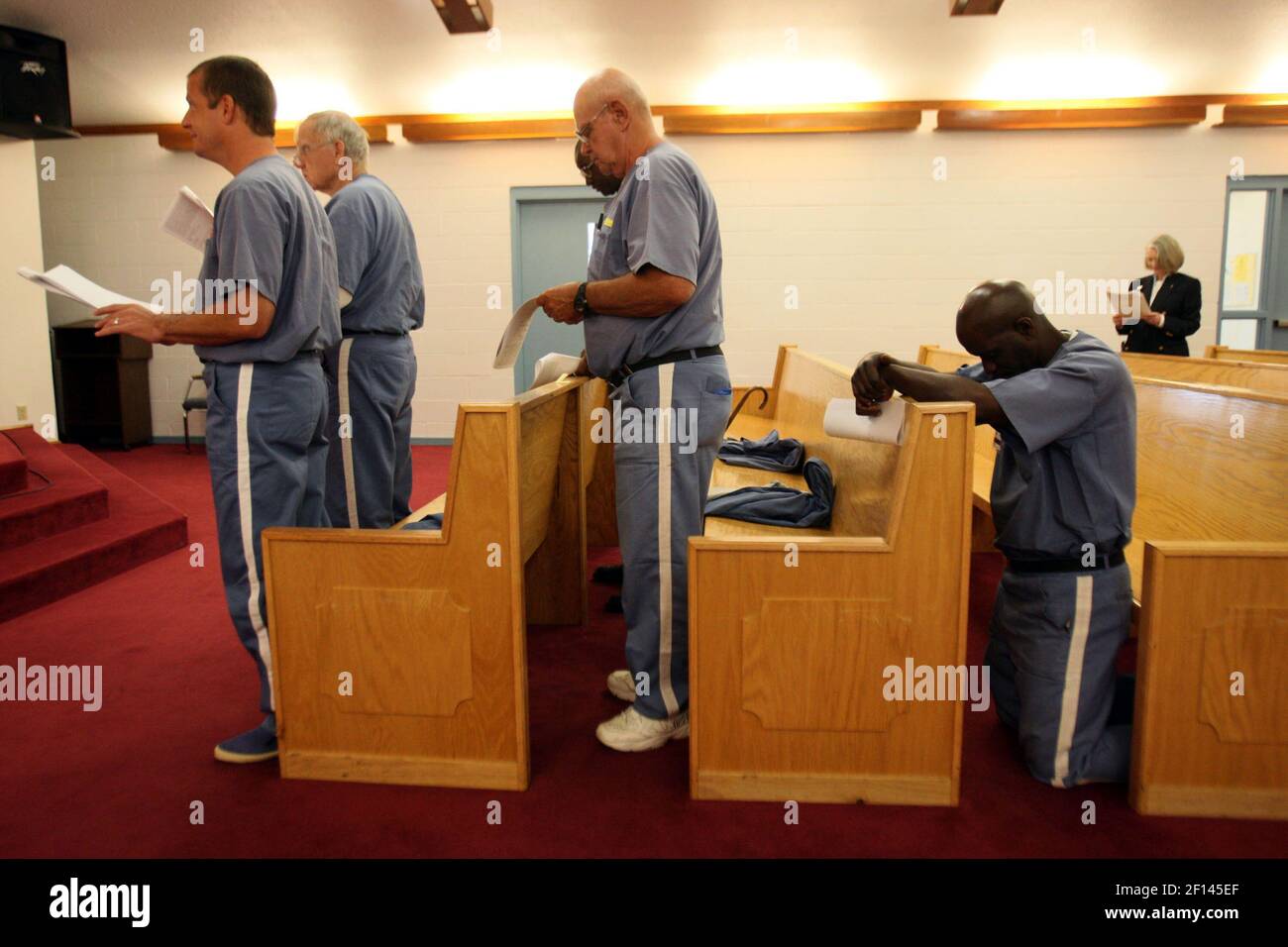 Prisoner Karl Stephen kneels during a service by Rev. J. Allison Defoor ...