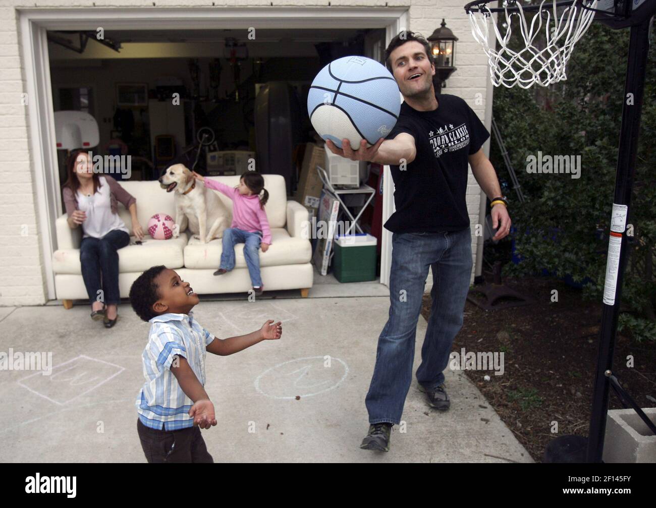 Steve Lackey, right, plays basketball with his adopted son, Caleb, 4 ...