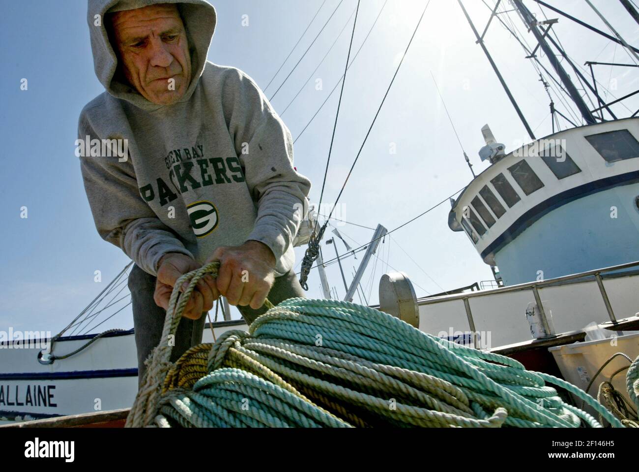 Fisherman Duncan MacLean gathers lines aboard his boat, the Barbara ...