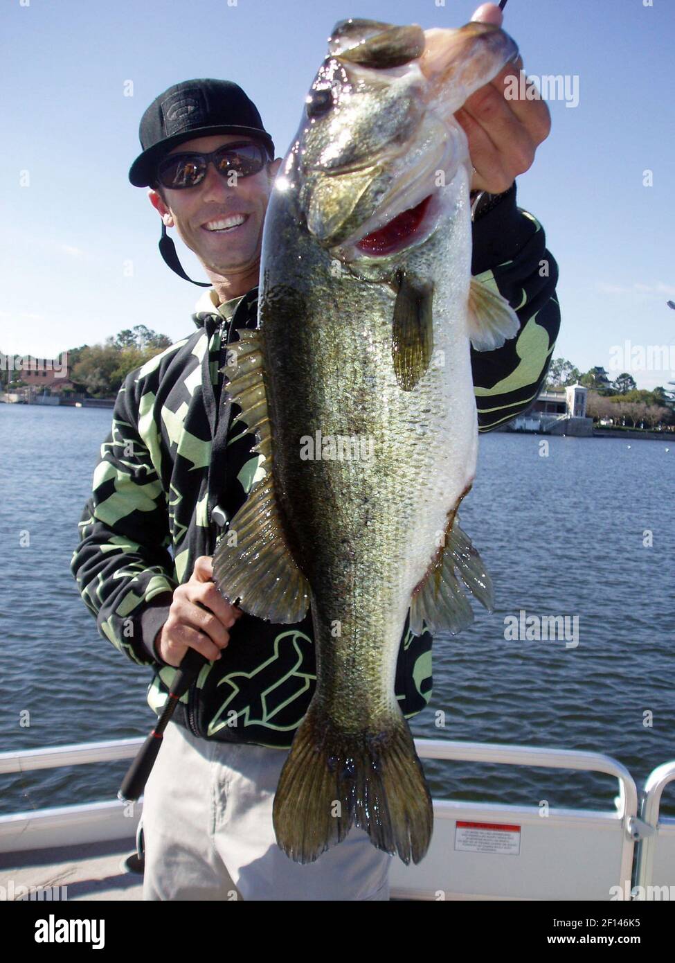 Mike Iaconelli holds up a six pound bass he caught on Crescent Lake at ...