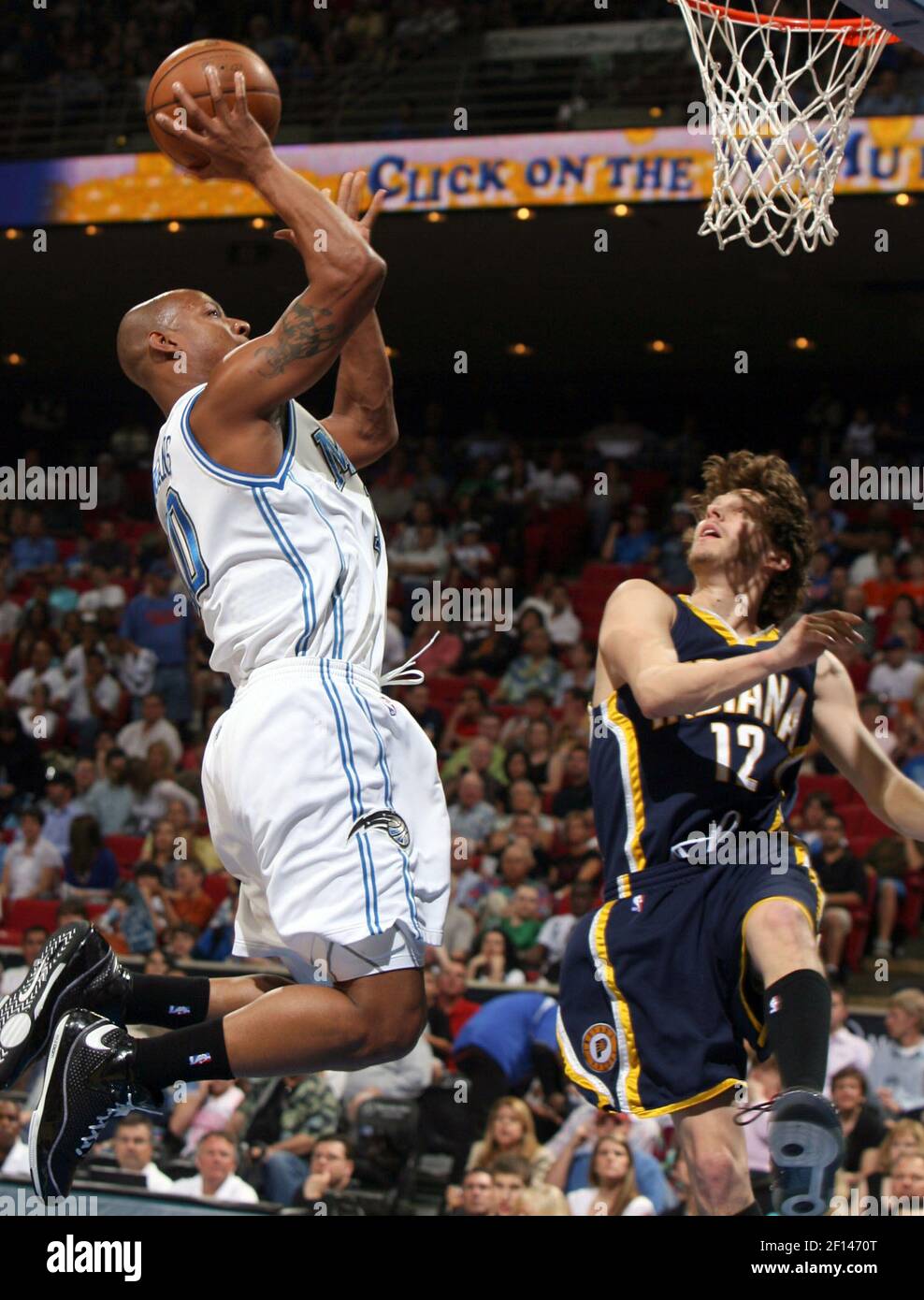 Orlando Magic guard Keith Bogans shoots over Indiana Pacers guard ...