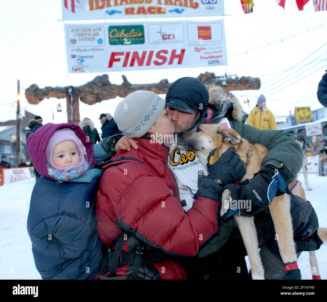 Sled dog musher Ramey Smyth gets a kiss from his wife Becca Moore as ...