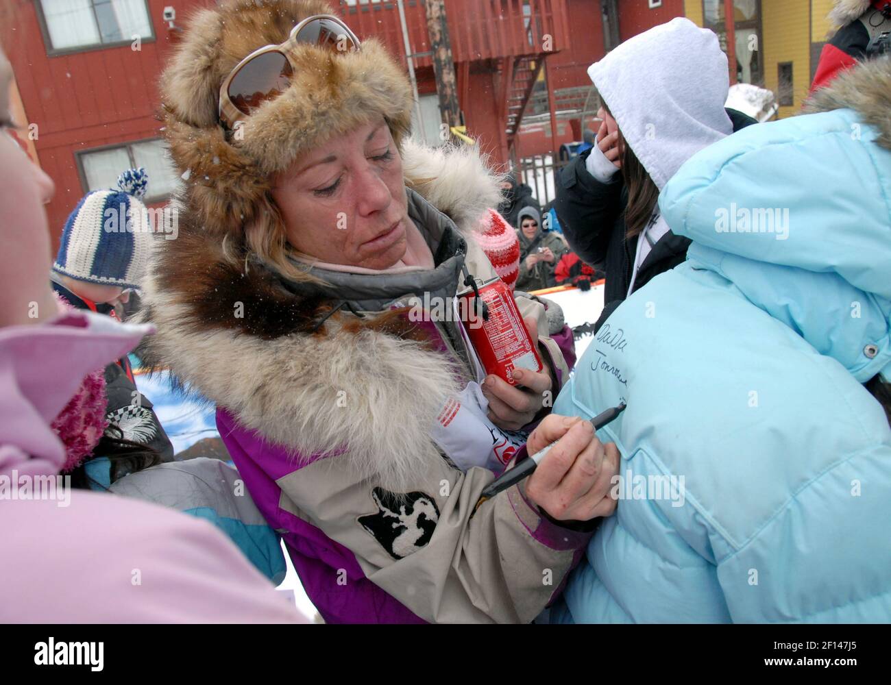 Iditarod musher DeeDee Jonrowe signs a spectator's jacket after she ...