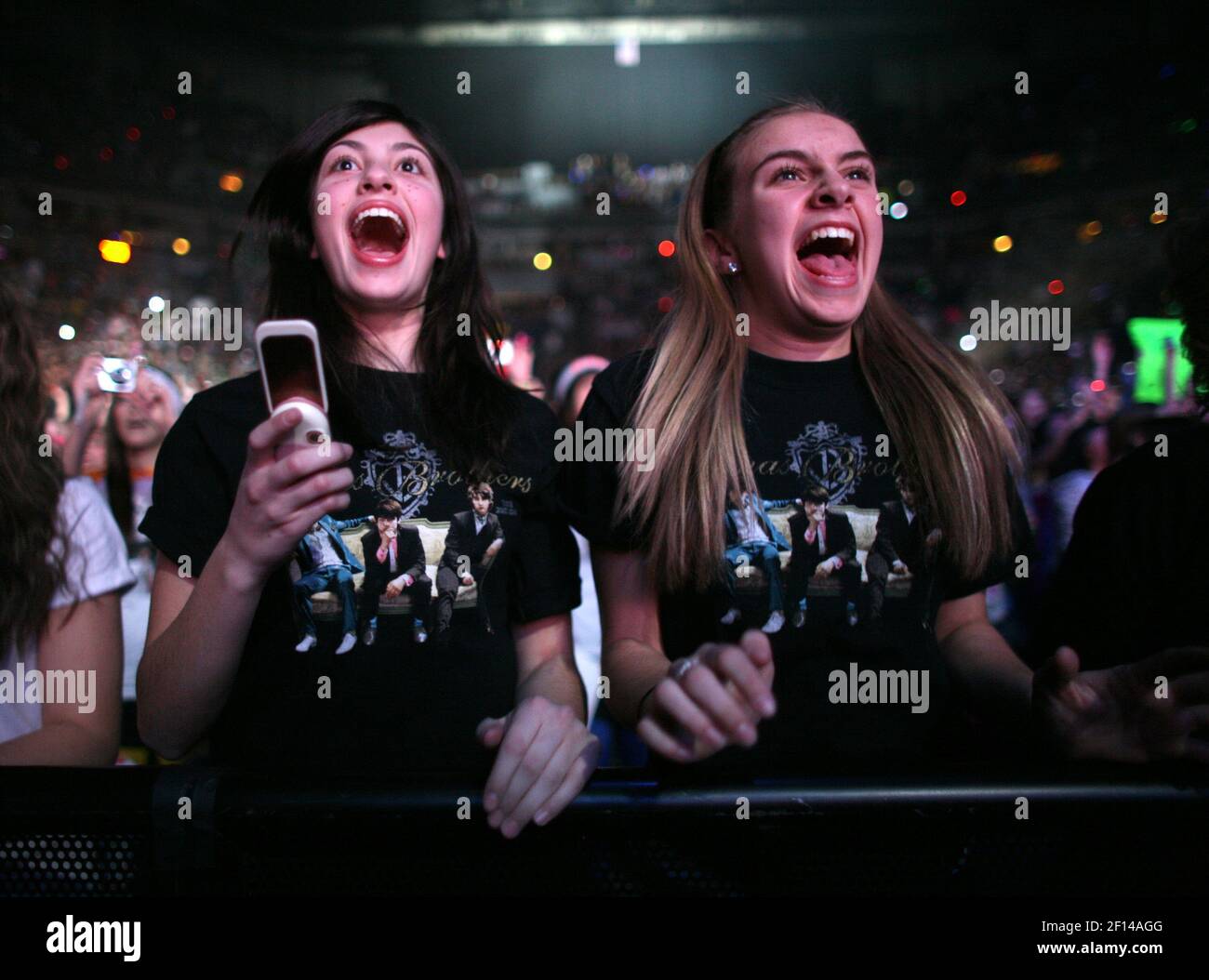 Two front row fans reacted as the Jonas Brothers take the stage at the ...