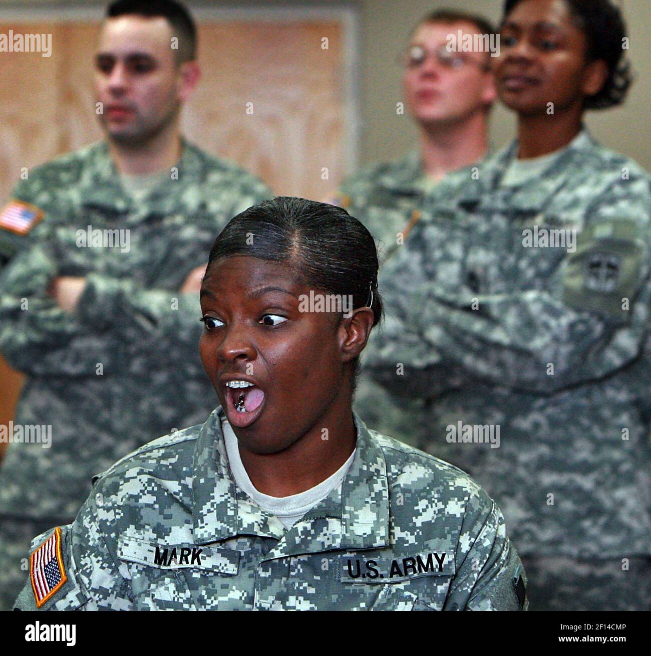 Army Staff Sgt. Barbara Mark is surprised by the hissing of the puff ...