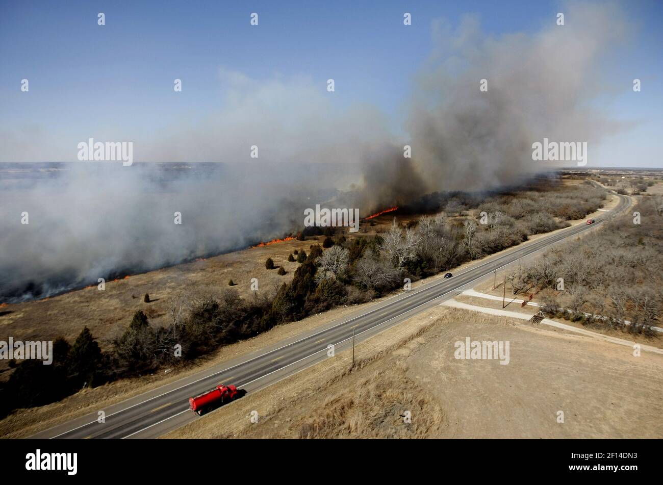 Chico fire fighters battle a wildfire north of Chico, Texas, as high ...