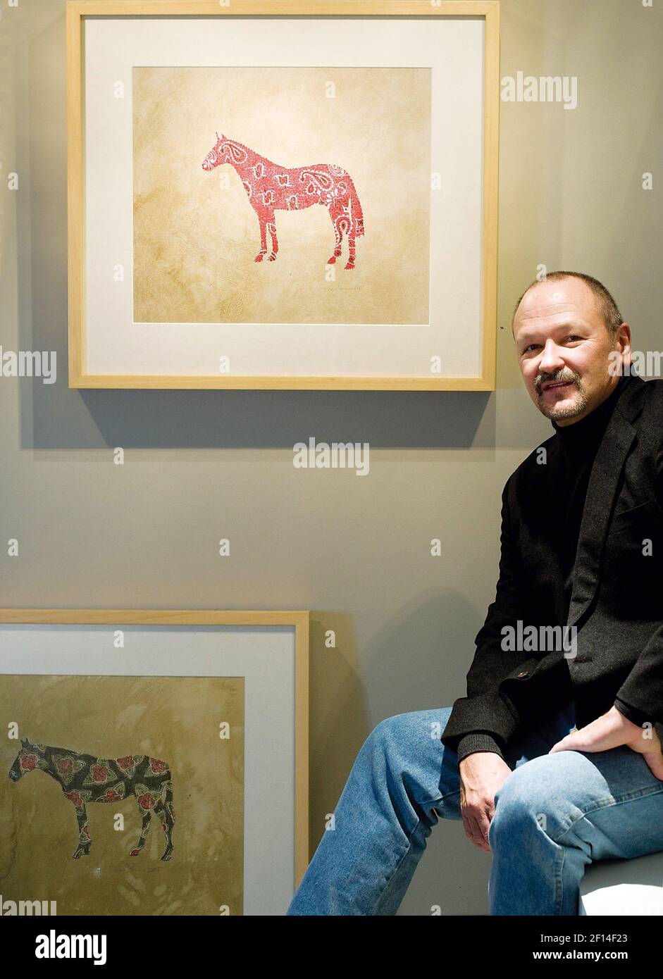 Artist Michael Bane in his Fort Worth studio with two paintings ...