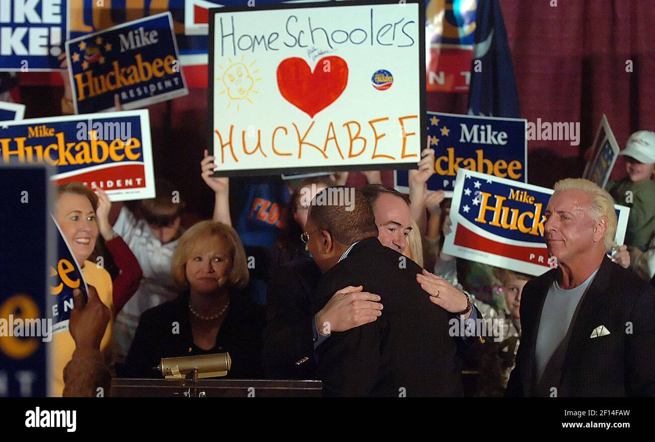 Republican presidential candidate Mike Huckabee hugs Glenn McCall ...